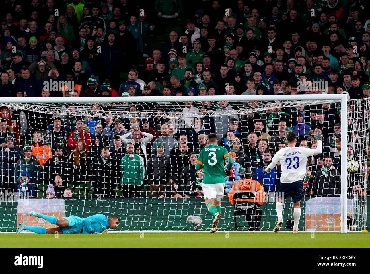 Republic of Ireland goalkeeper Gavin Bazunu (left) fails to stop Norway ...