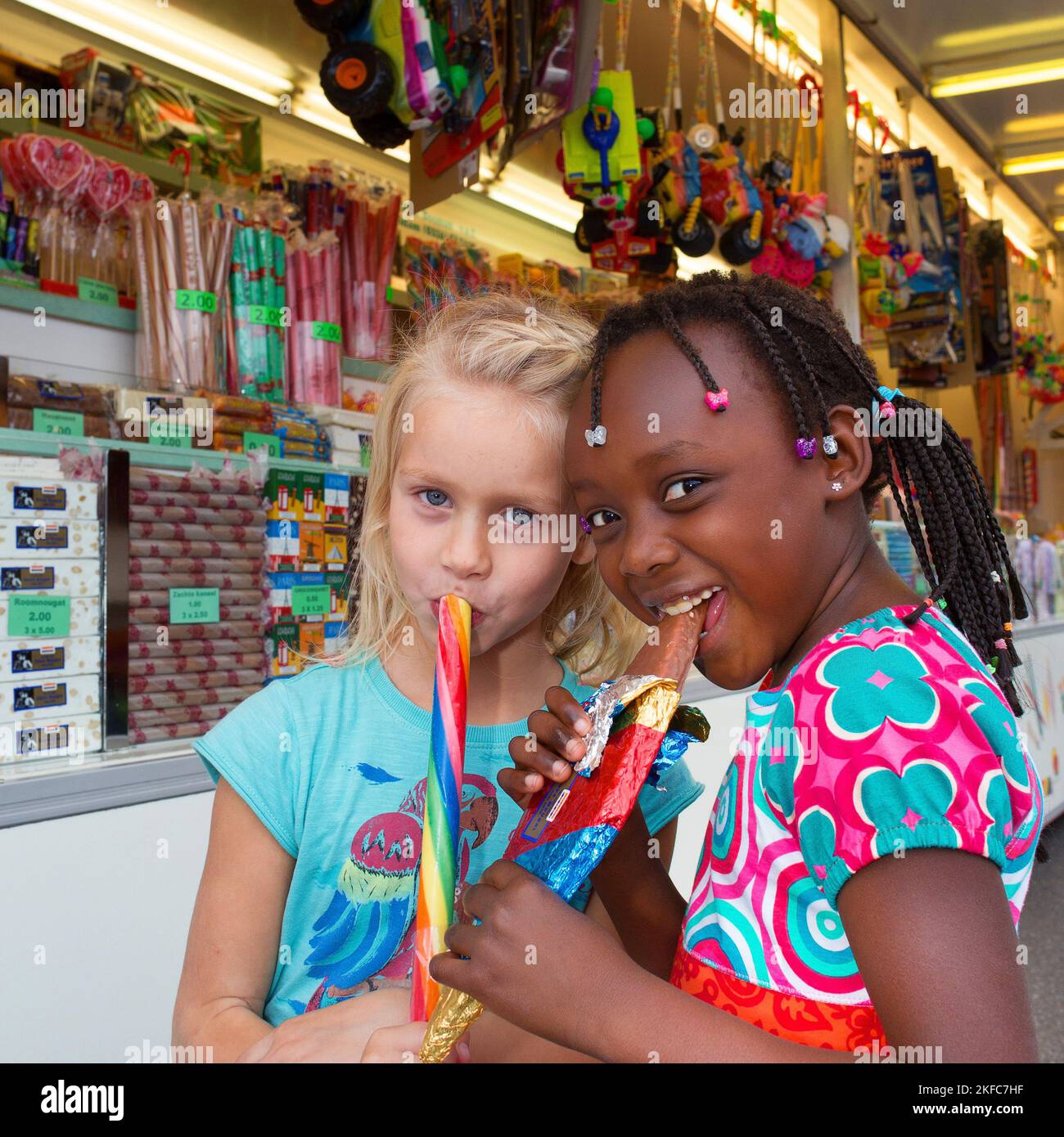 two little girls at a candy stal with a candy cane at a fair . Duiven ...