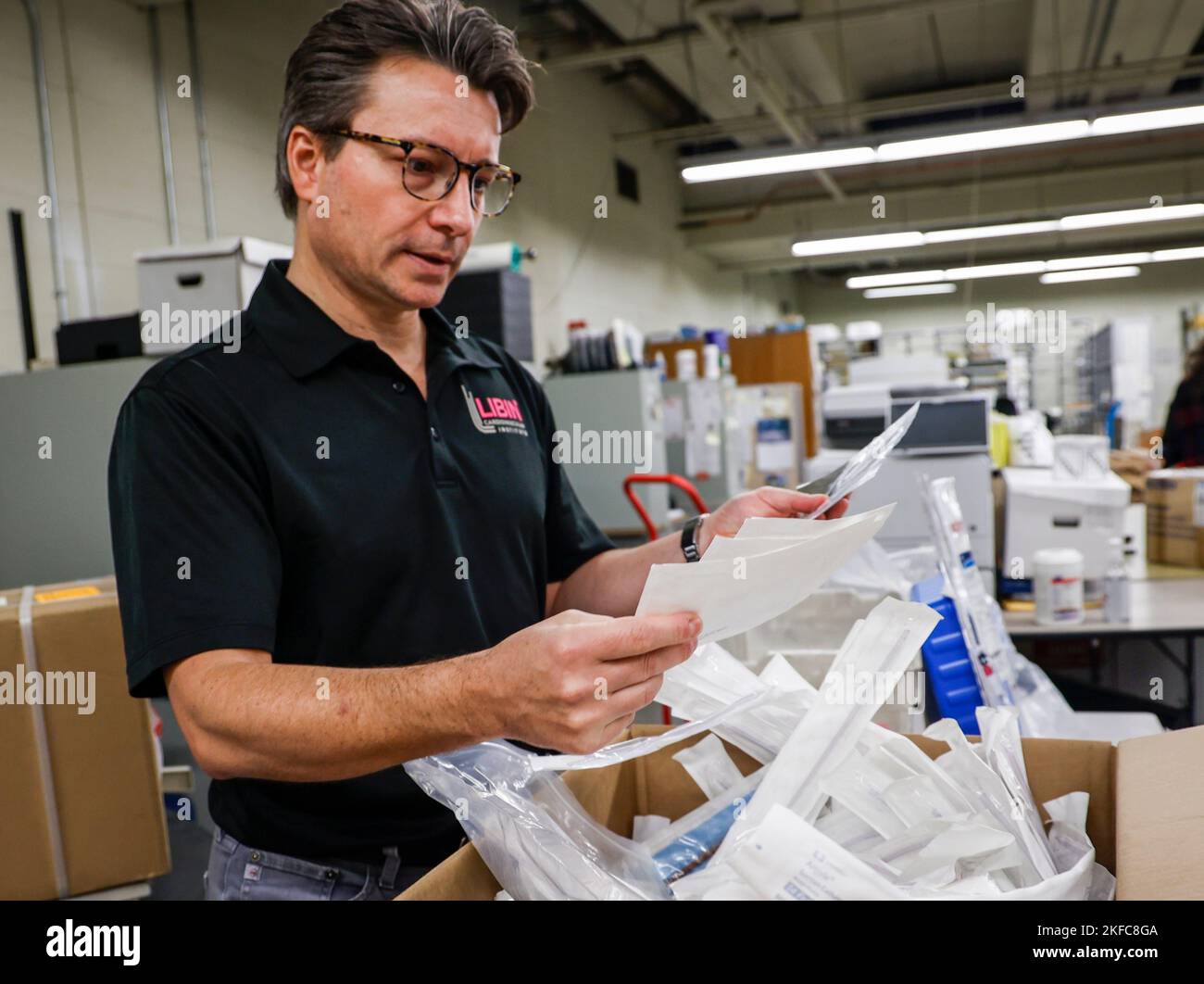 Dr. Paul Fedak sorts through medical and surgical supplies destined for ...