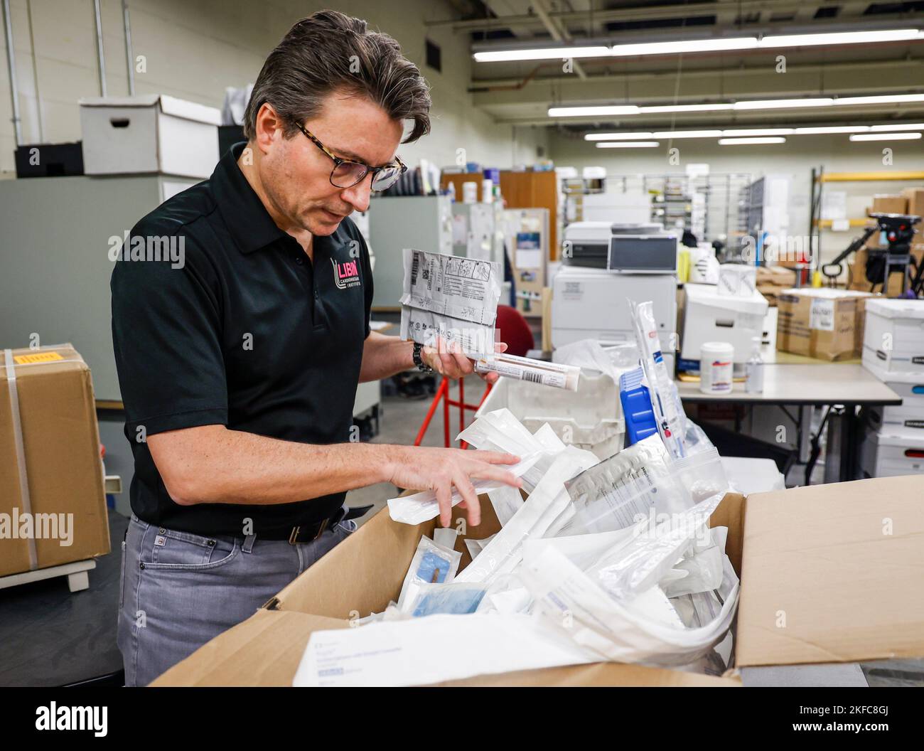 Dr. Paul Fedak sorts through medical and surgical supplies destined for ...