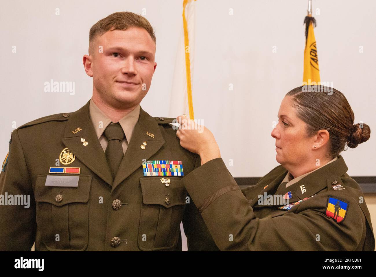 U.S. Army 2nd Lt. David Crowe, left, stands at attention while U.S ...