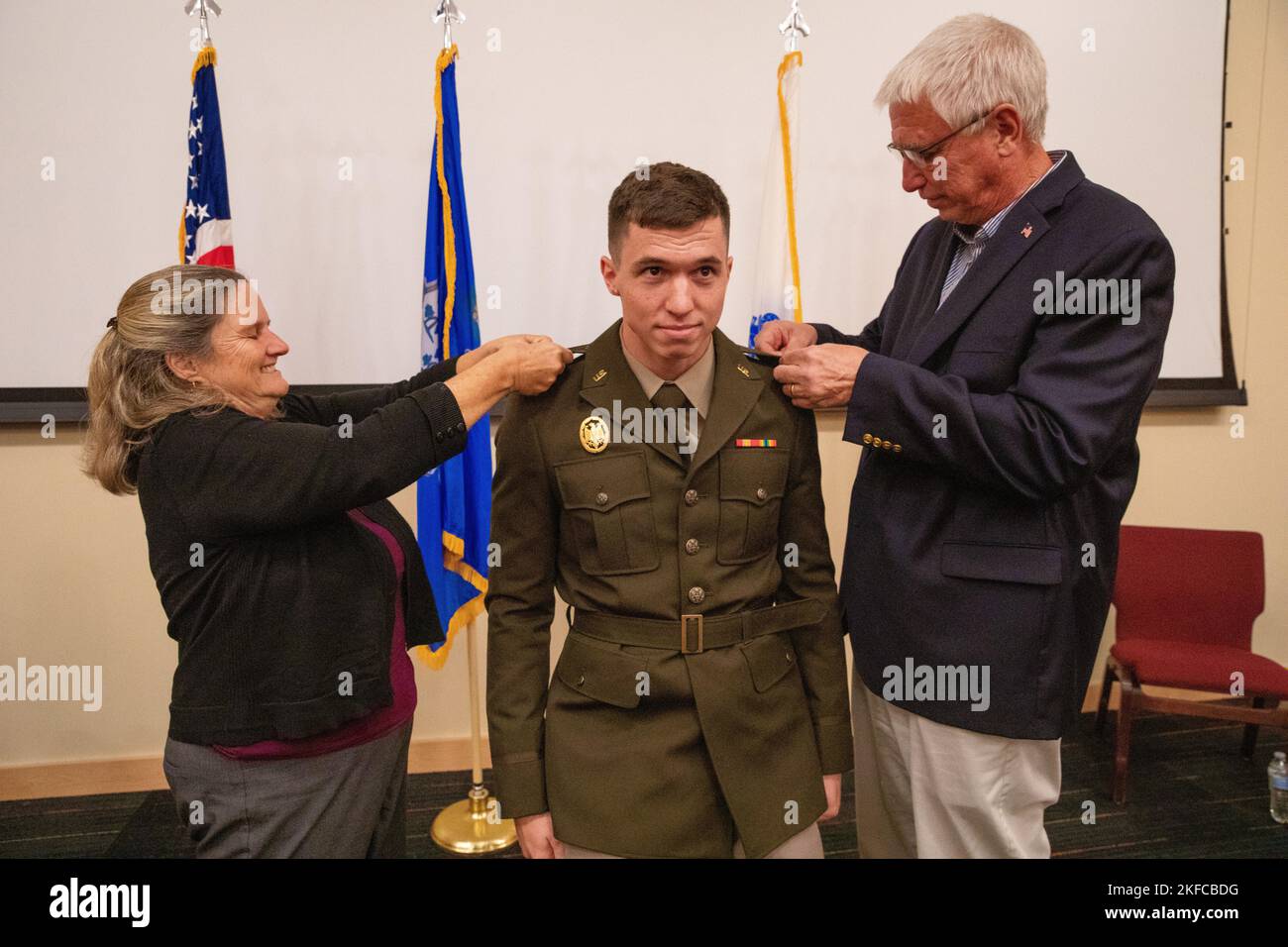 U.S. Army 2nd Lt. Brian Goggin leans down so his family, Susan Goggin ...