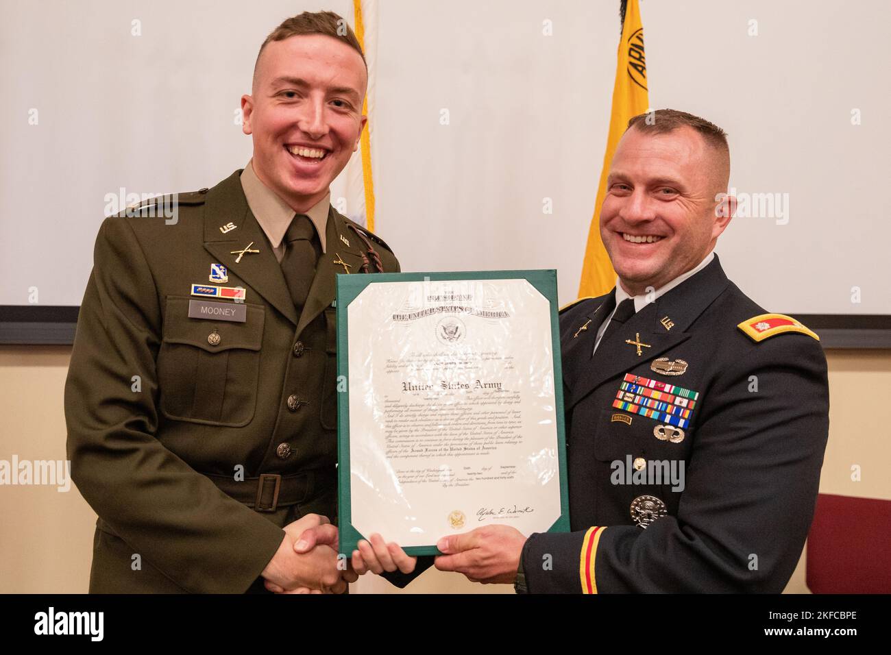 U.S. Army 2nd Lt. Luke Mooney, left, receives his appointment certificate from U.S. Army Lt. Col ...