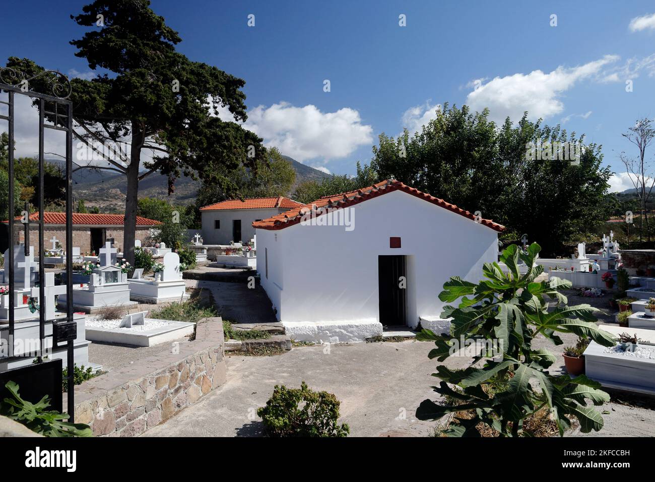 Small white church with well kept graveyard, near Petra. Lesbos views ...