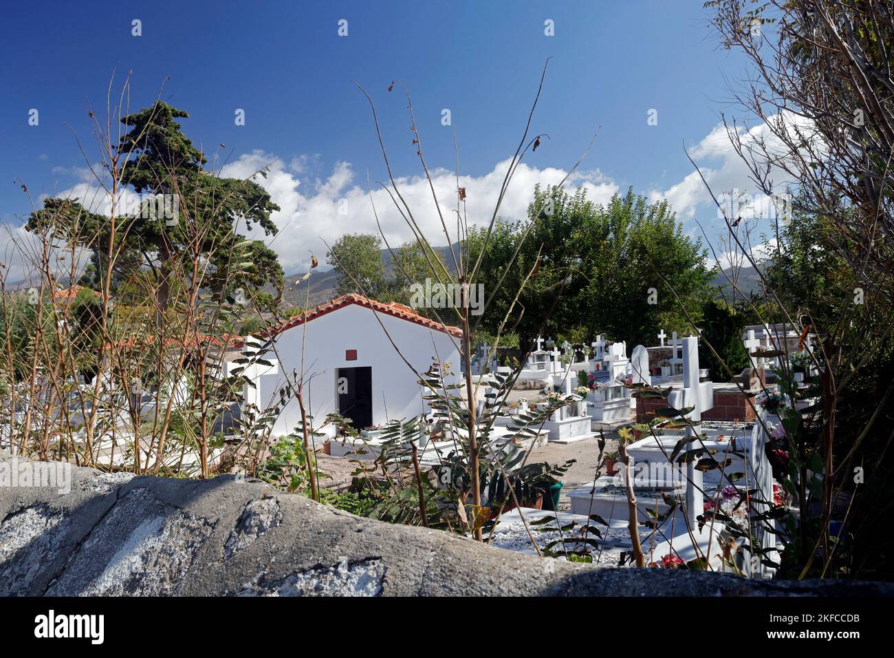 Small white church with well kept graveyard, near Petra. Lesbos views ...