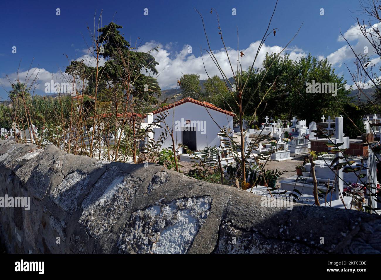 Small white church with well kept graveyard, near Petra. Lesbos views ...