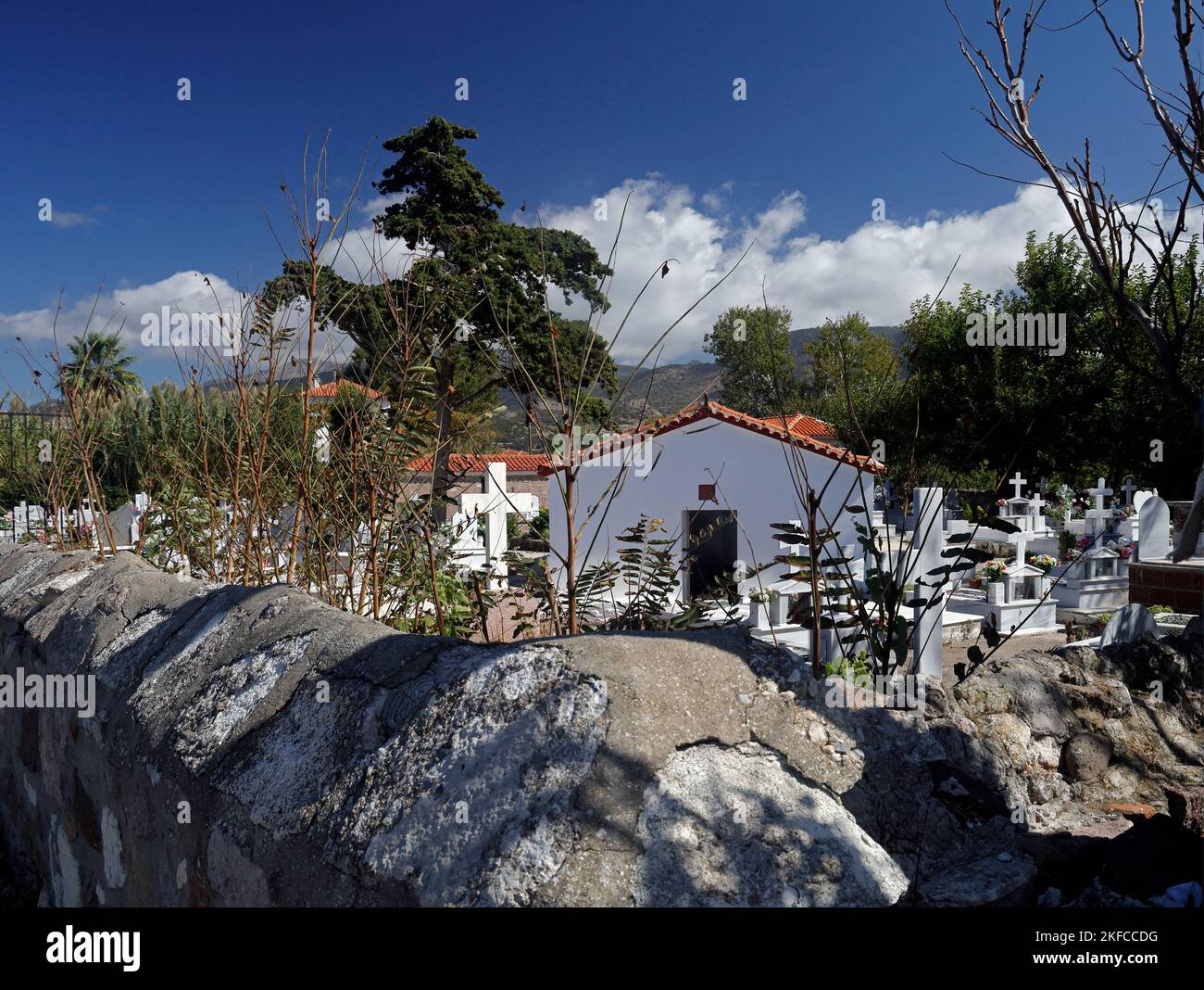 Small white church with well kept graveyard, near Petra. Lesbos views ...