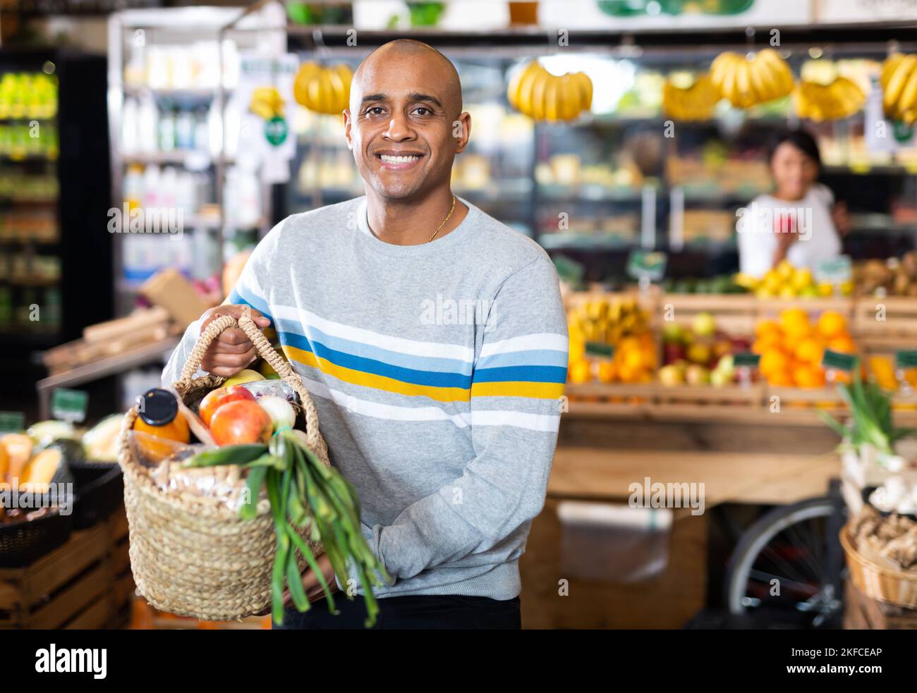 Happy latin american man with purchases in grocery store Stock Photo ...