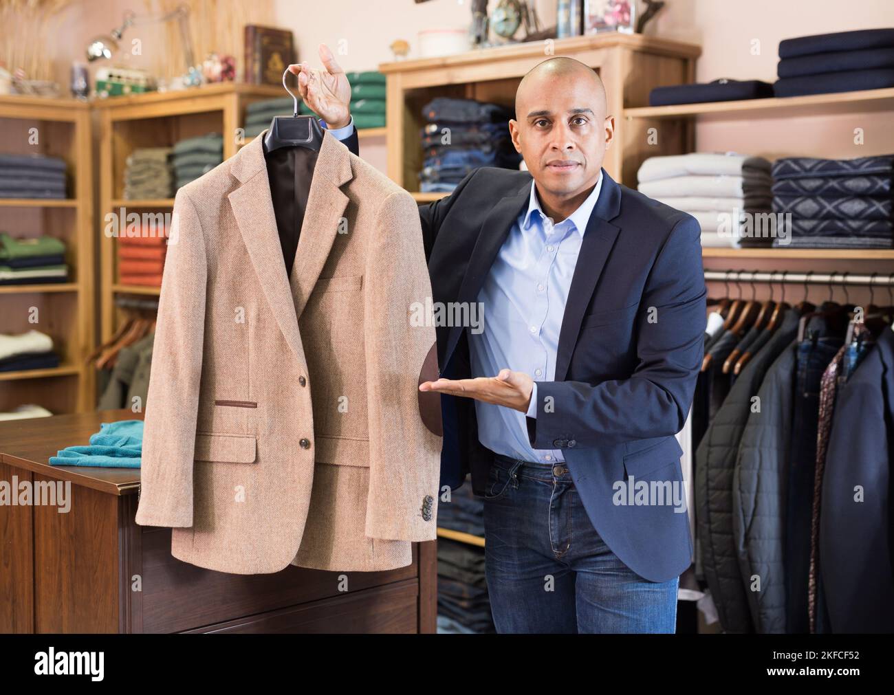 Positive young salesman demonstrating hi-res stock photography and ...