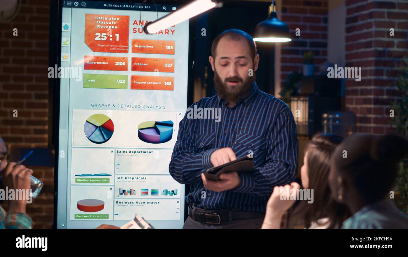 Company analyst explaining statistics diagrams, giving presentation in ...