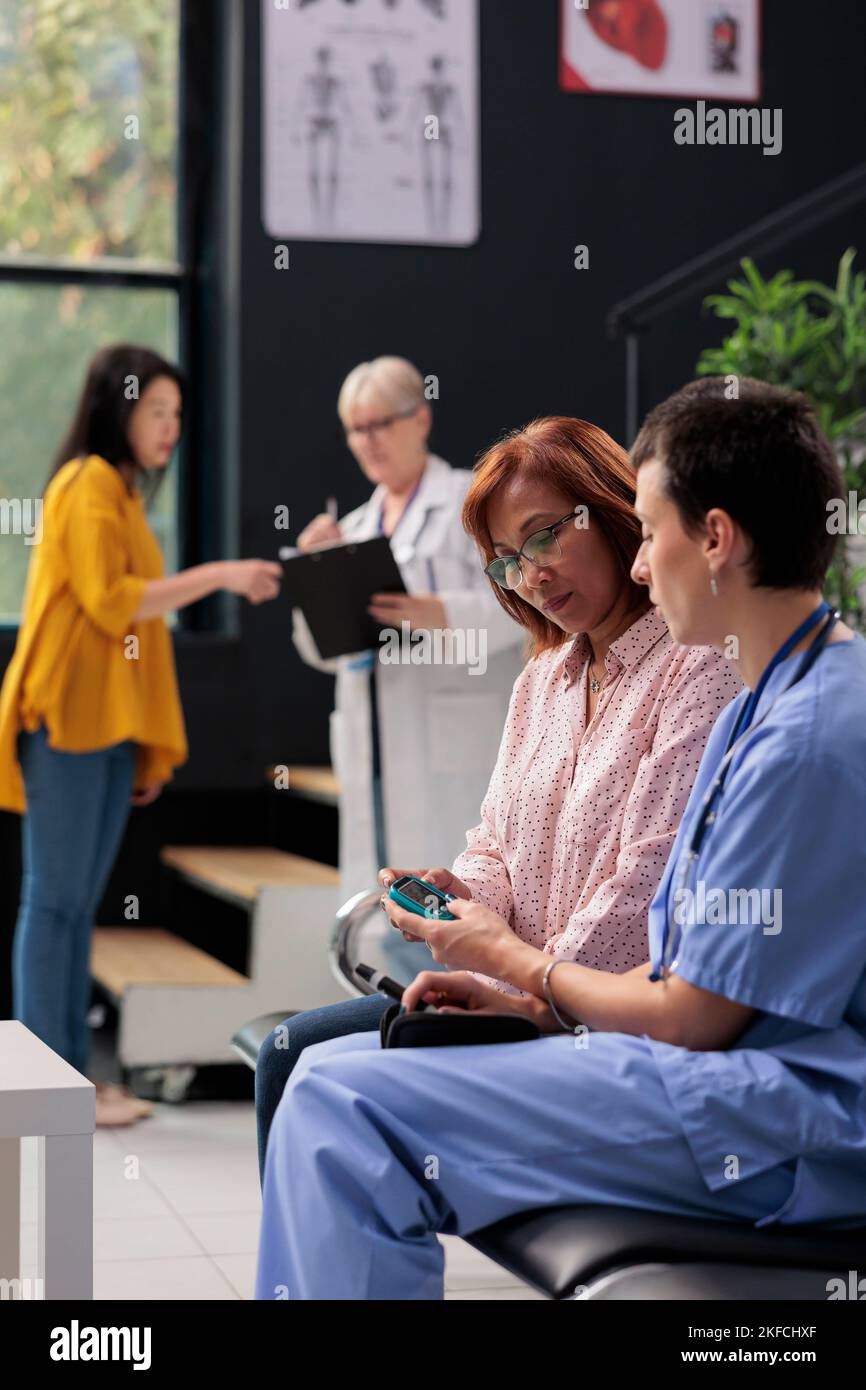 Health specialist measuring insulin level and glucose in blood sample ...