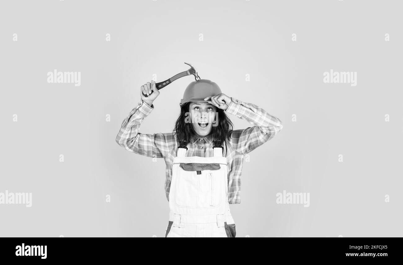 Your master builder. young female worker on beige background. repair ...