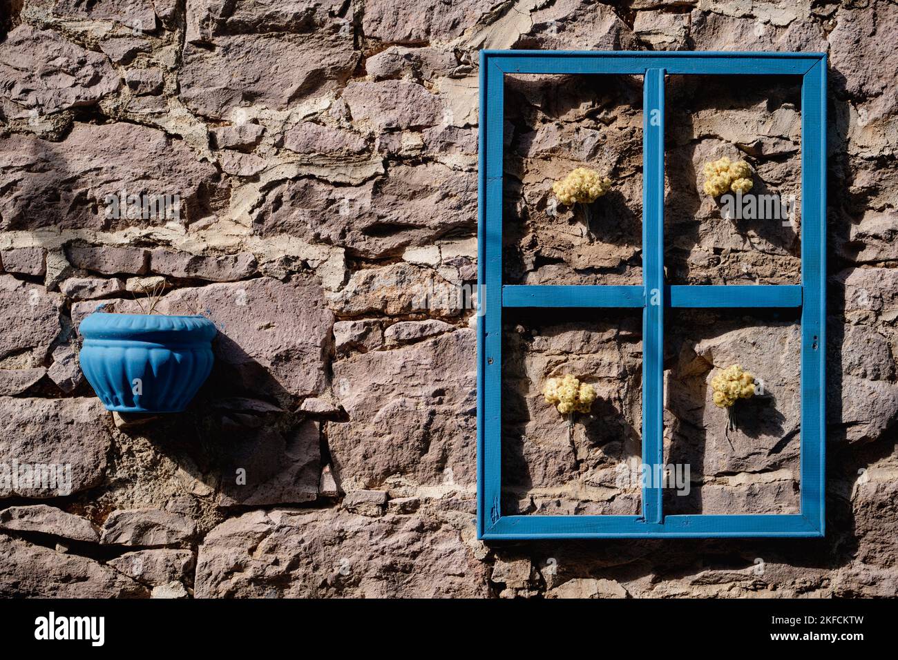Old blue window frame on a stone wall Stock Photo - Alamy