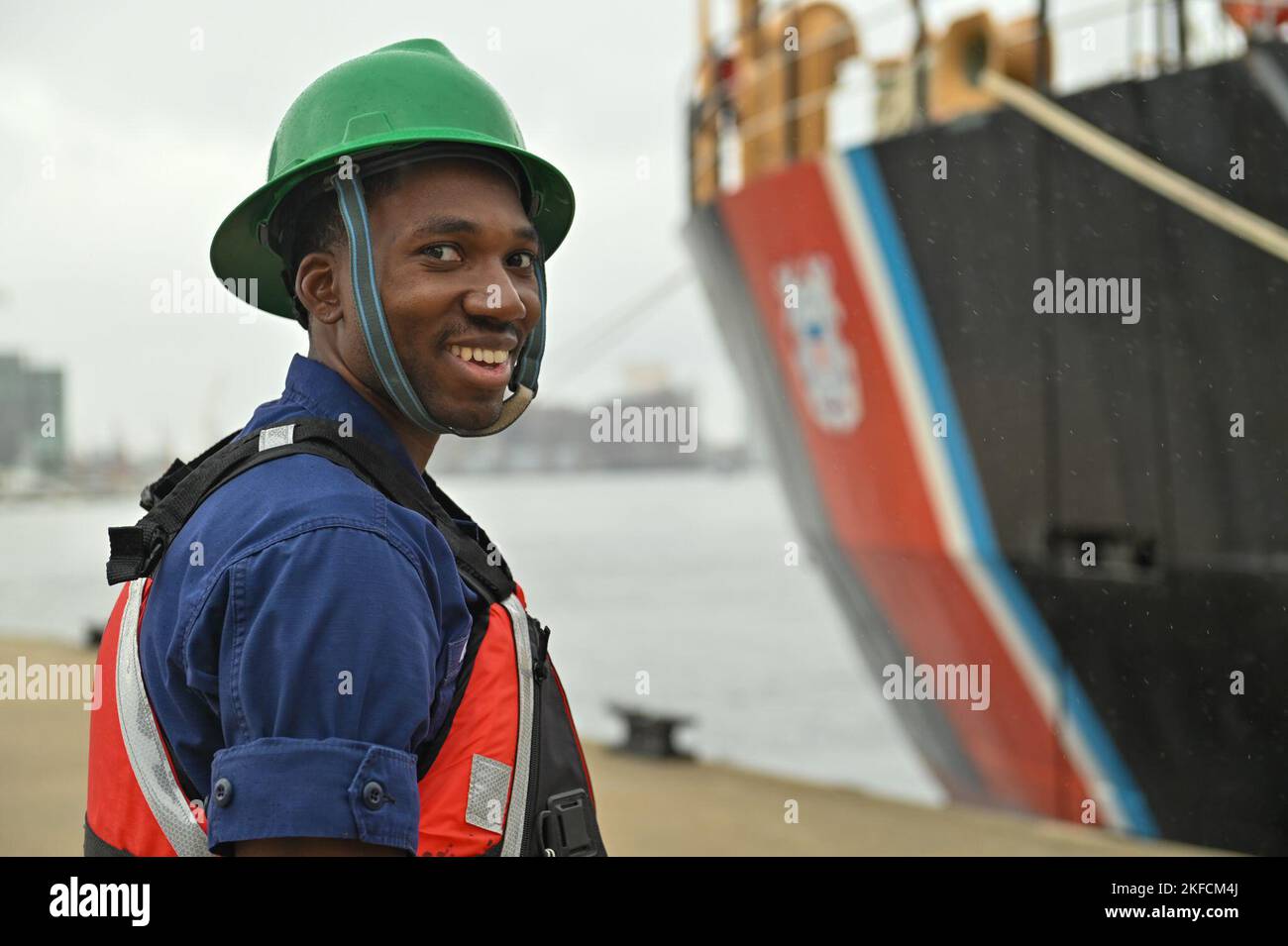 A crew member from Coast Guard Cutter James Rankin moors the Rankin in ...