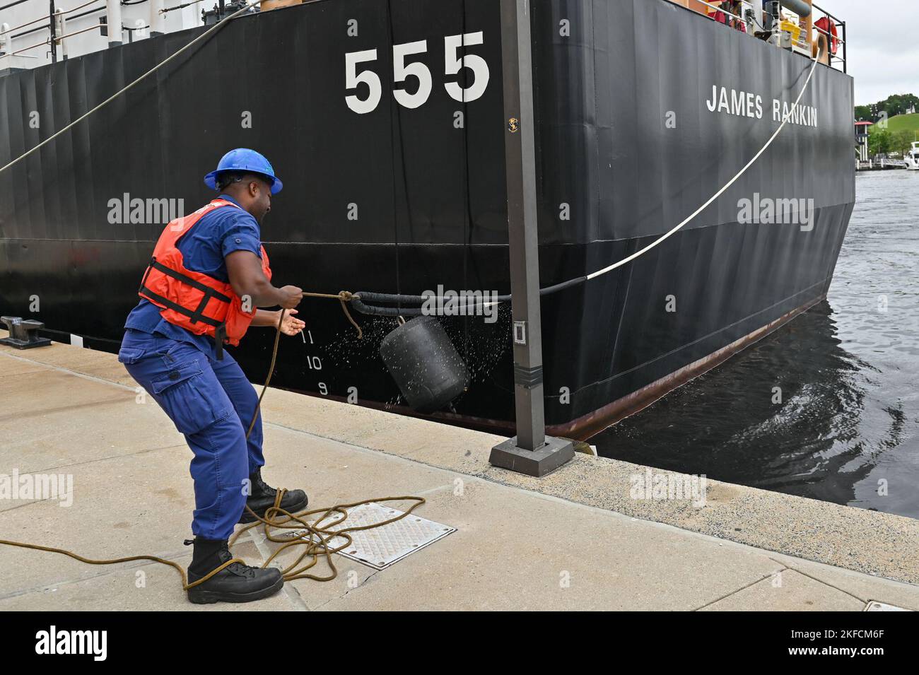 A crew member from Coast Guard Cutter James Rankin moors the Rankin in ...