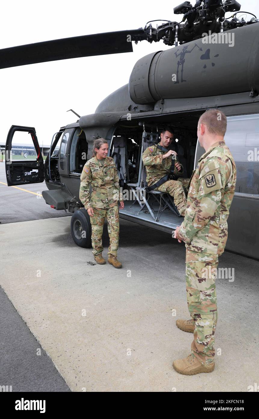 North Carolina Army National Guard Spc. Sarah Moore (Center, left), of ...