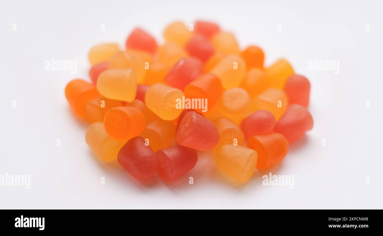 Selective focus, close-up texture of orange and yellow multivitamin ...