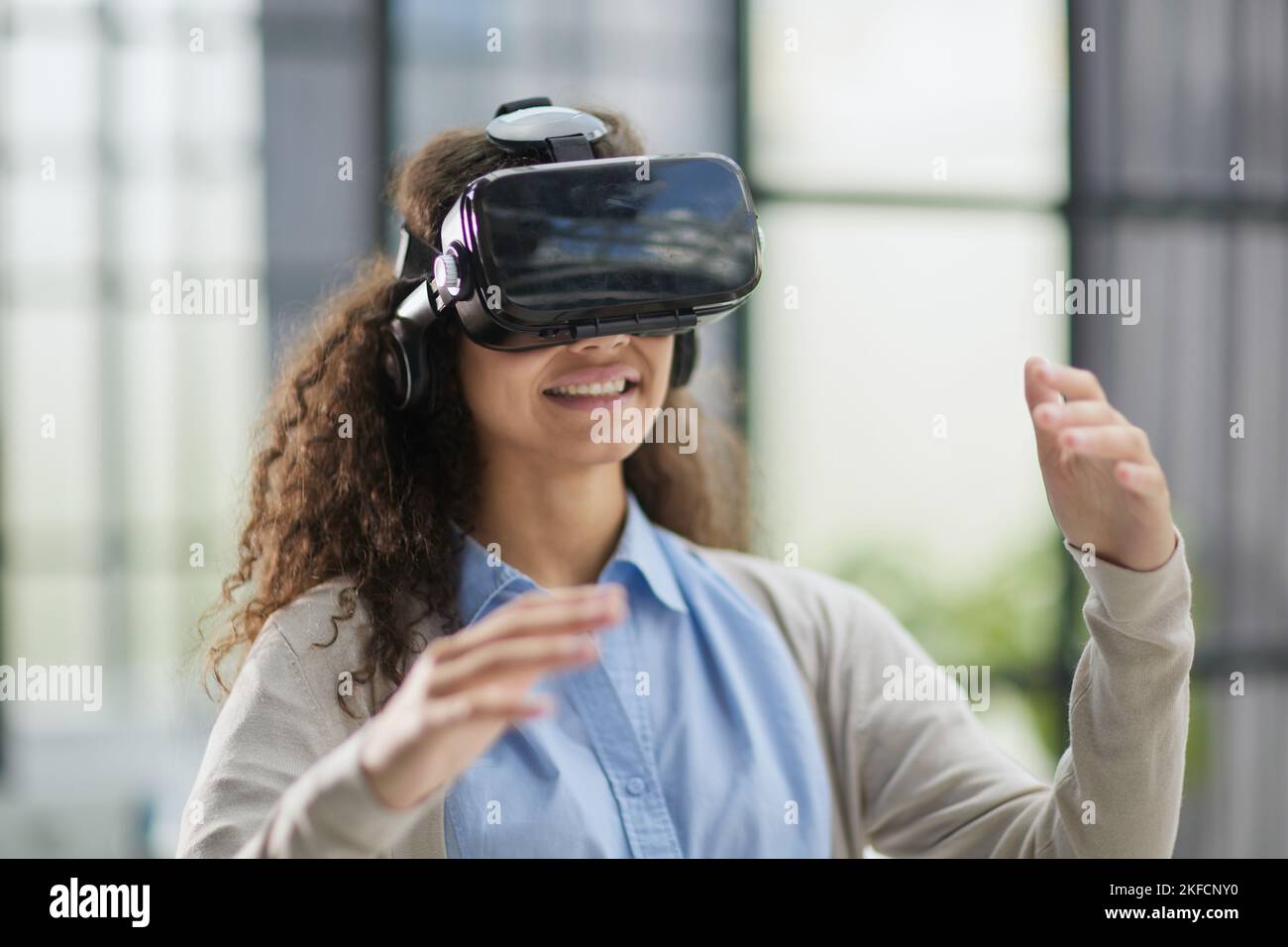 Girl trying to touch objects in virtual reality Stock Photo - Alamy