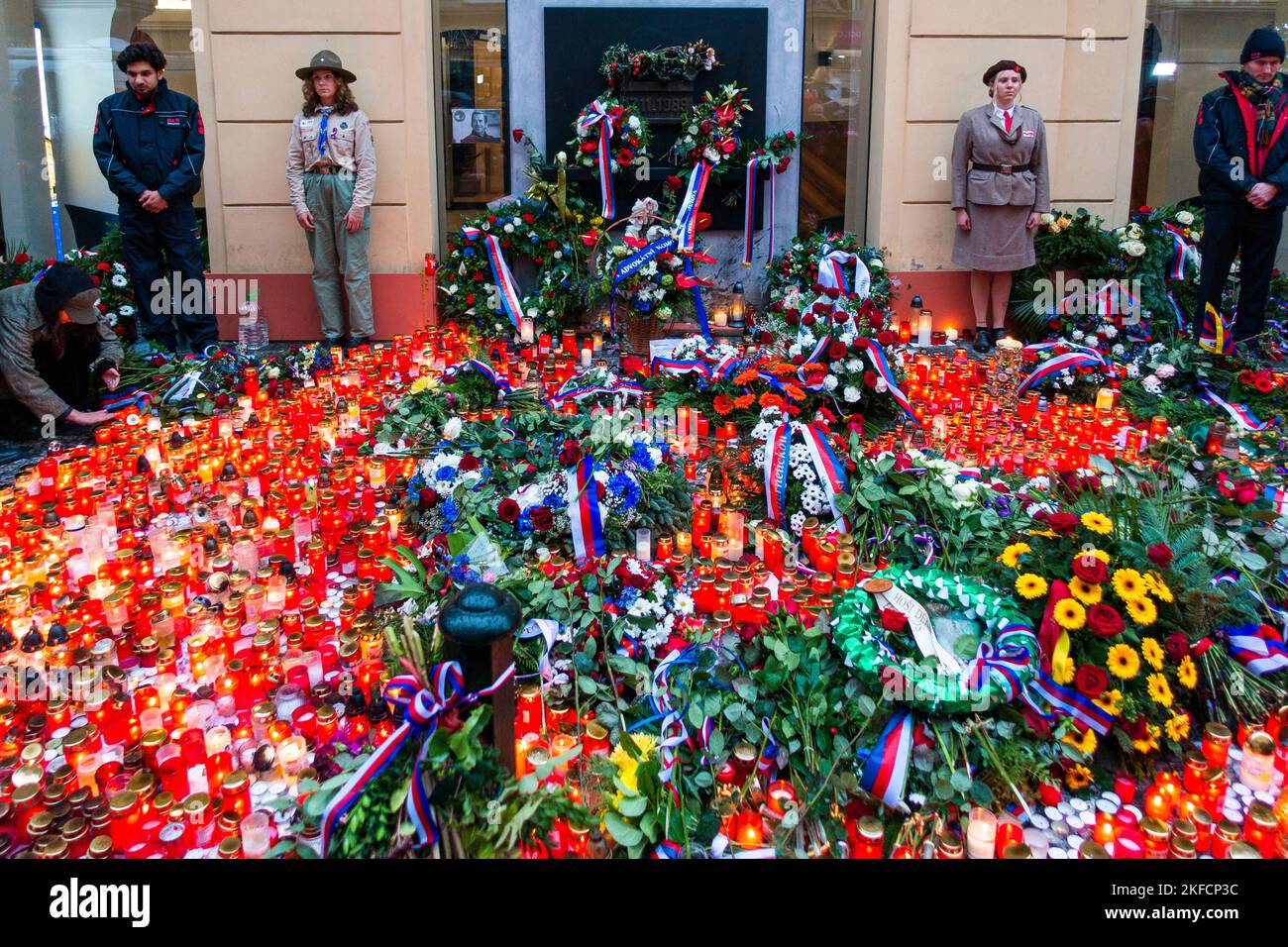 People light candles below the memorial plaque marking the November ...