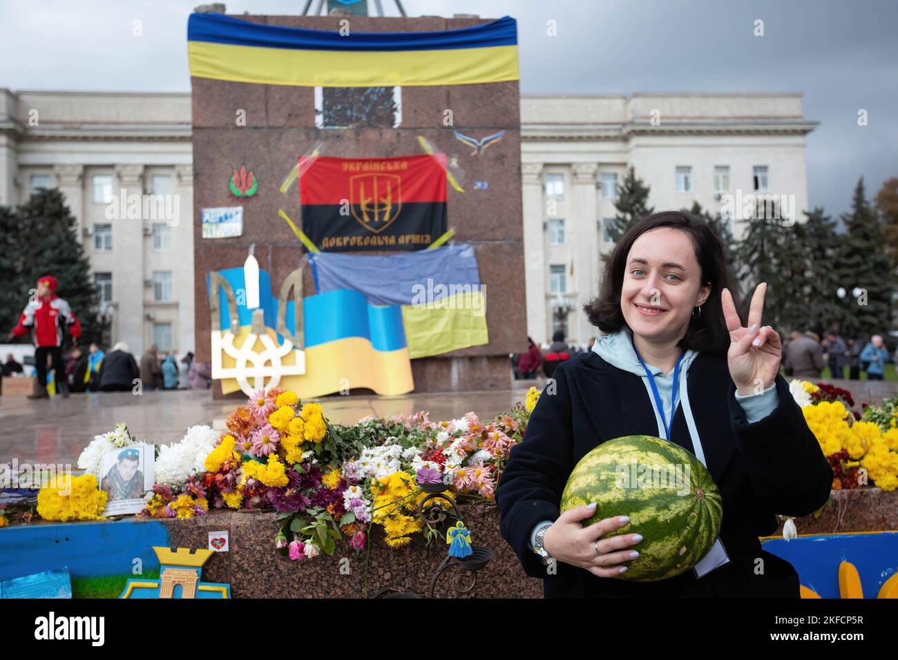 A woman with a watermelon poses for a photo at the central square of ...