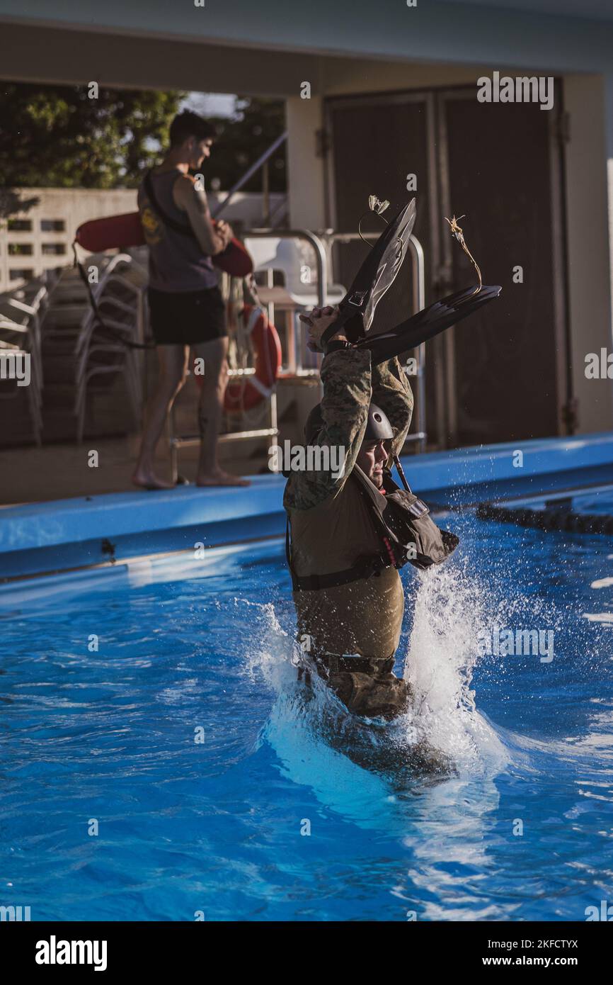 A U.S. Marine with III Marine Expeditionary Force, jumps into the water ...