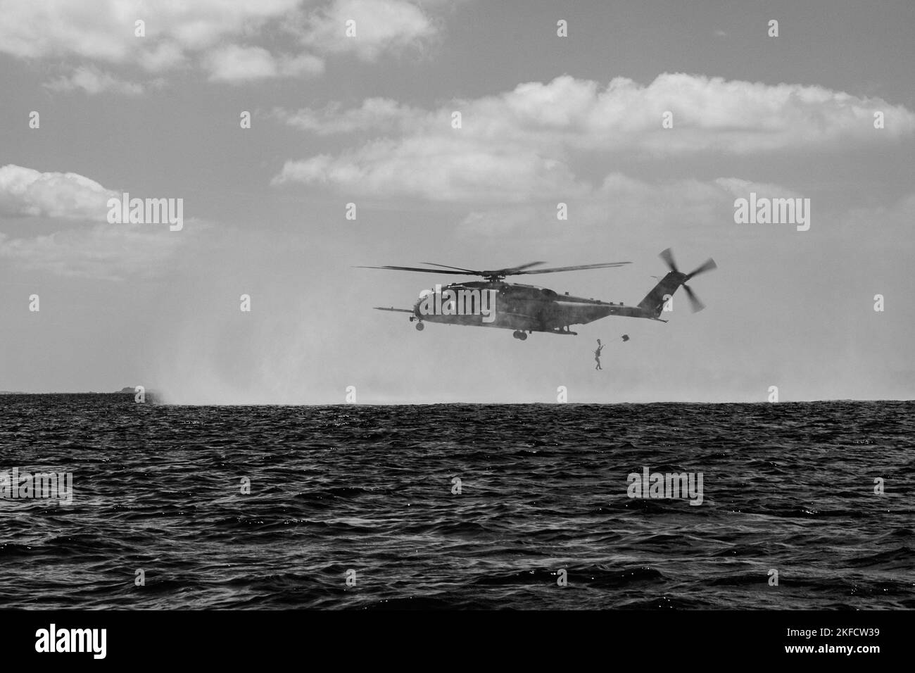 A U.S. Marine with III Marine Expeditionary Force (MEF), jumps from a ...