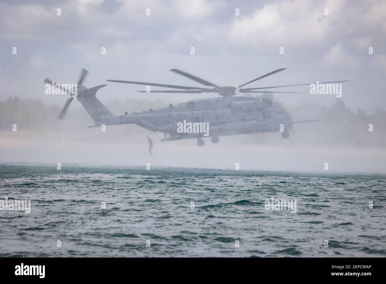 A U.S. Marine with III Marine Expeditionary Force (MEF), jumps from a ...