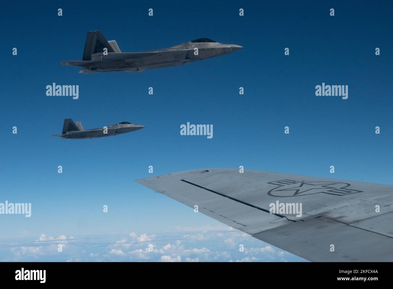 The inbound and outbound commanders of the 154th Wing fly F-22 Raptors ...