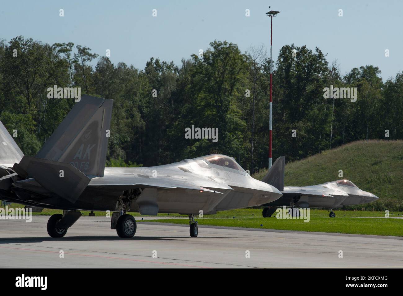 U.S. Air Force F-22 Raptors assigned to the 90th Expeditionary Fighter ...