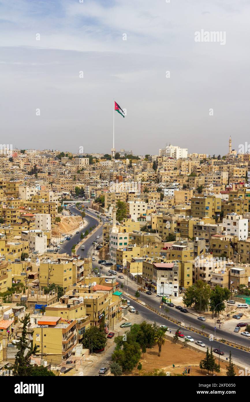A vertical shot of the Raghadan Flagpole in the background of Amman ...