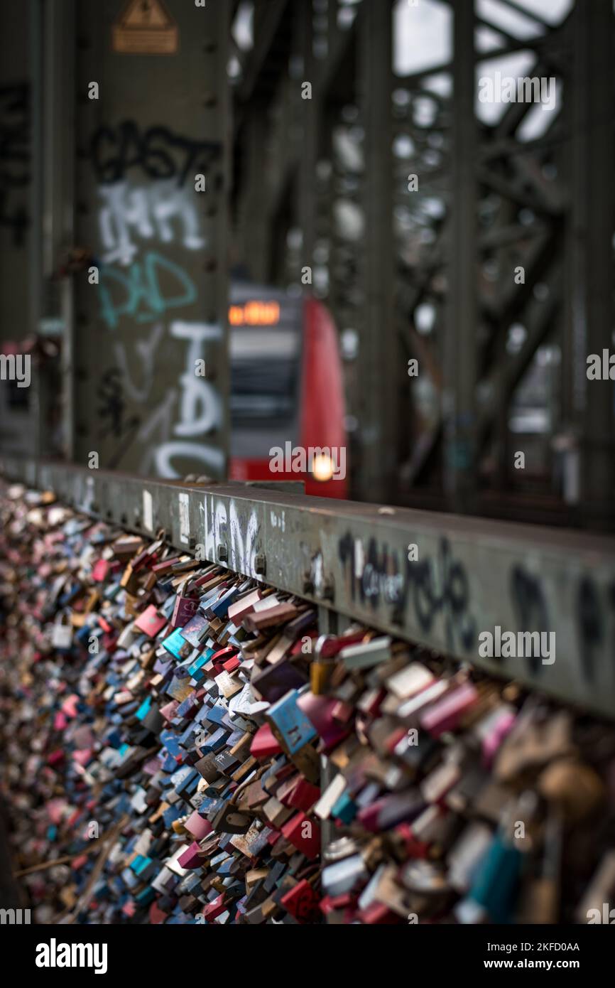 A vertical shot of many of padlocks hanging on Hohenzollern Bridge in ...