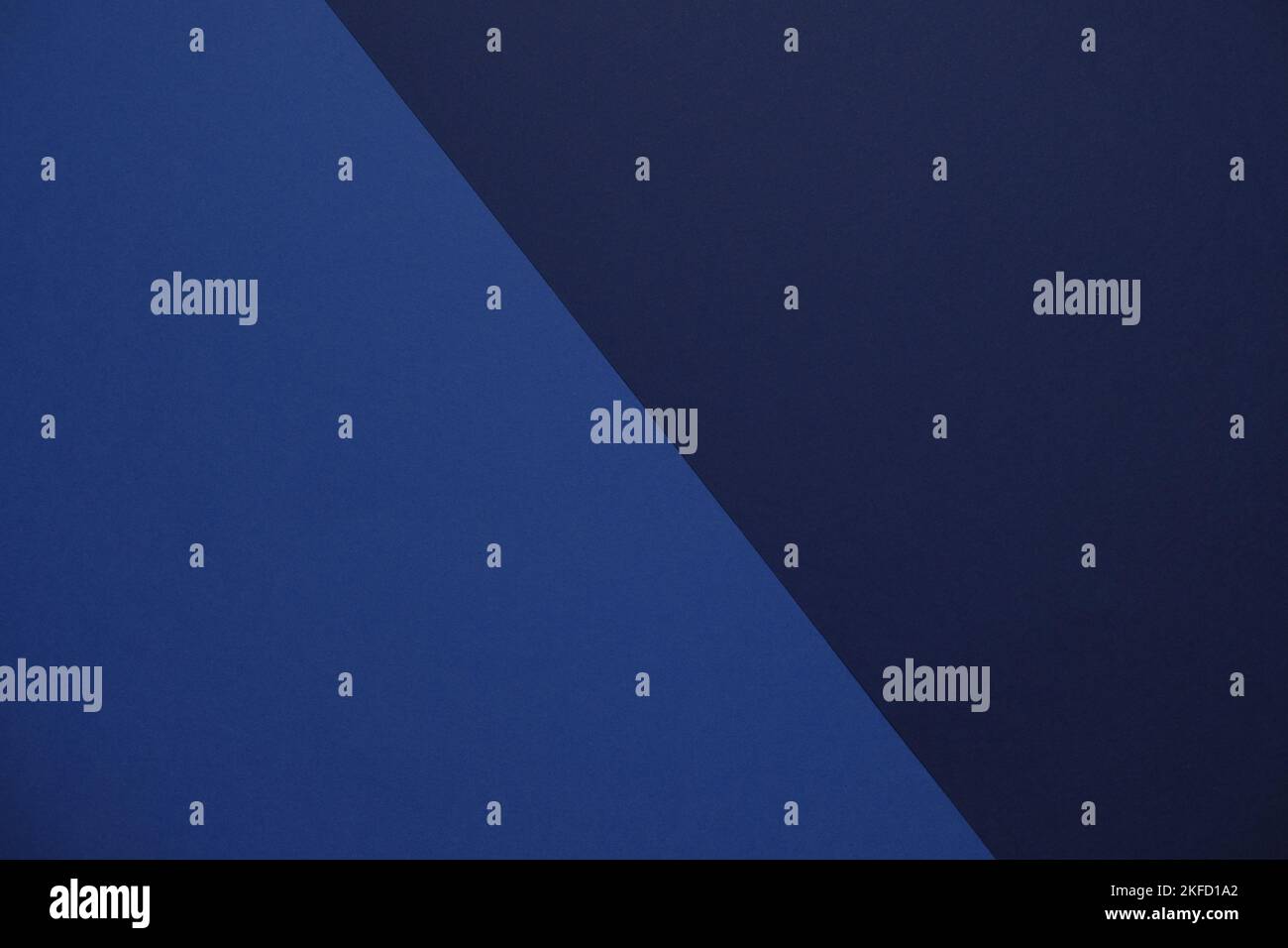 Textured wallpaper in two shades of blue separated by diagonal line ...