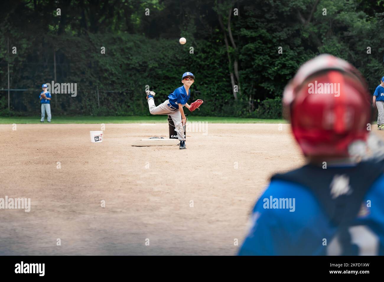 The kids playing baseball in the park Stock Photo - Alamy