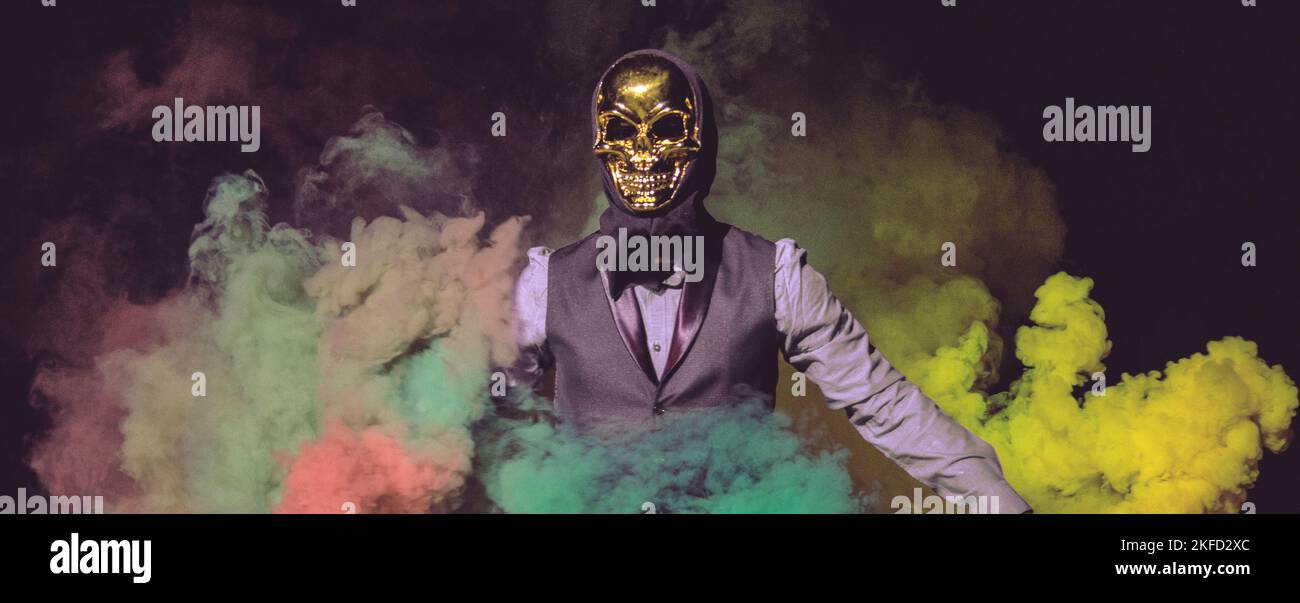 A man with a custom of a Devil coming out of the smoke Stock Photo - Alamy