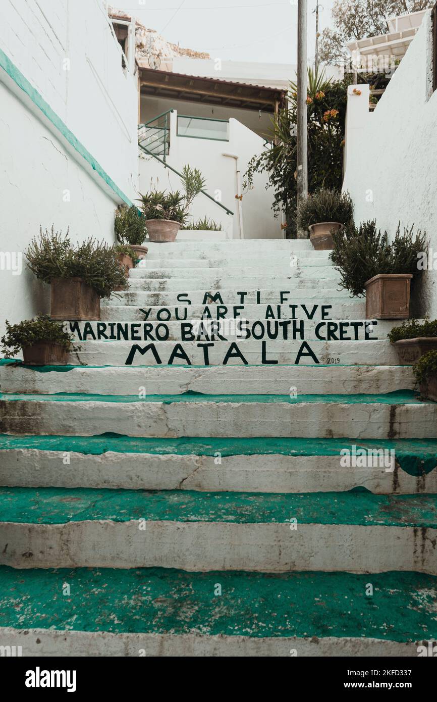 A staircase with written messages in the small village of Matala in ...