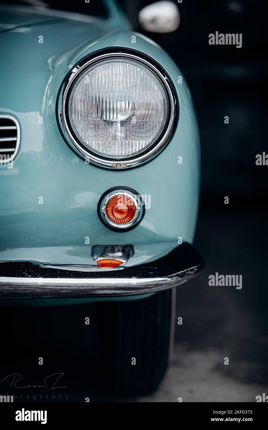 A vertical shot of vintage blue Volkswagen Karmann Ghia in the garage ...