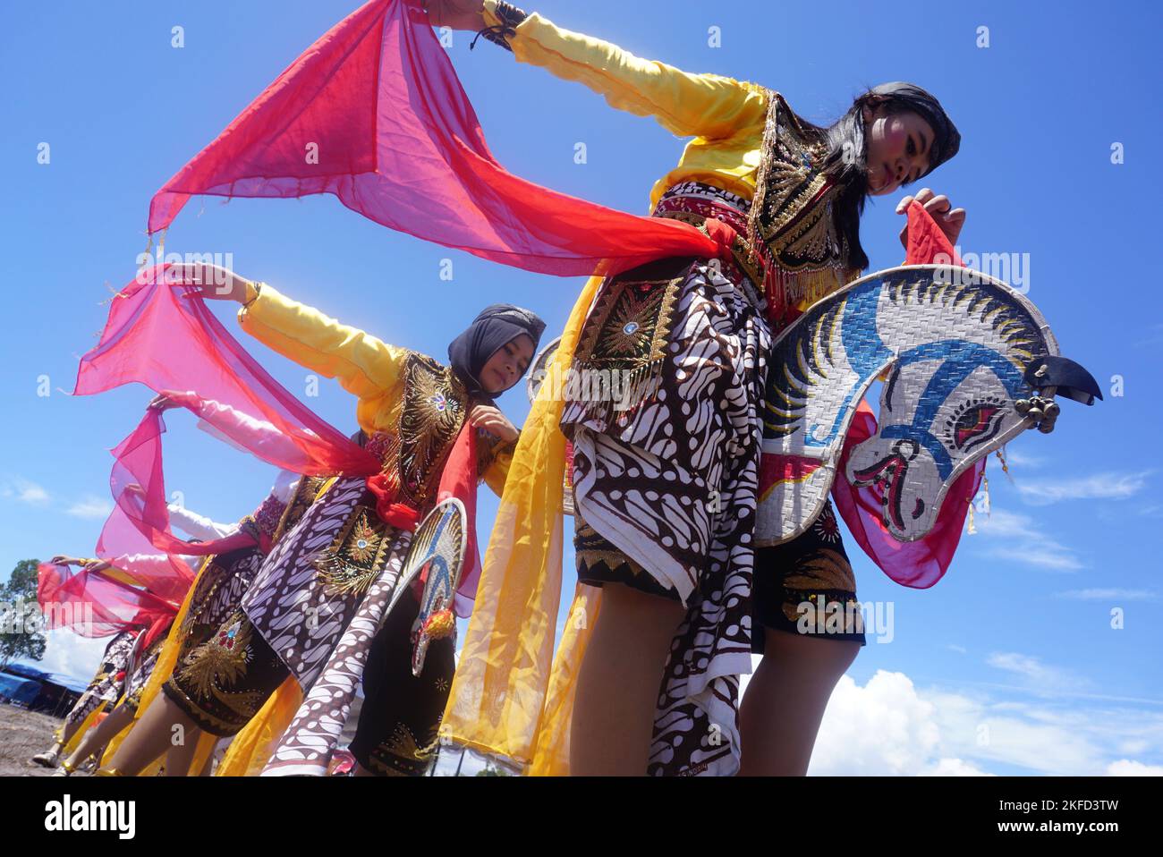 The low-angle view of Kuda Lumping dancers under the blue sky ...