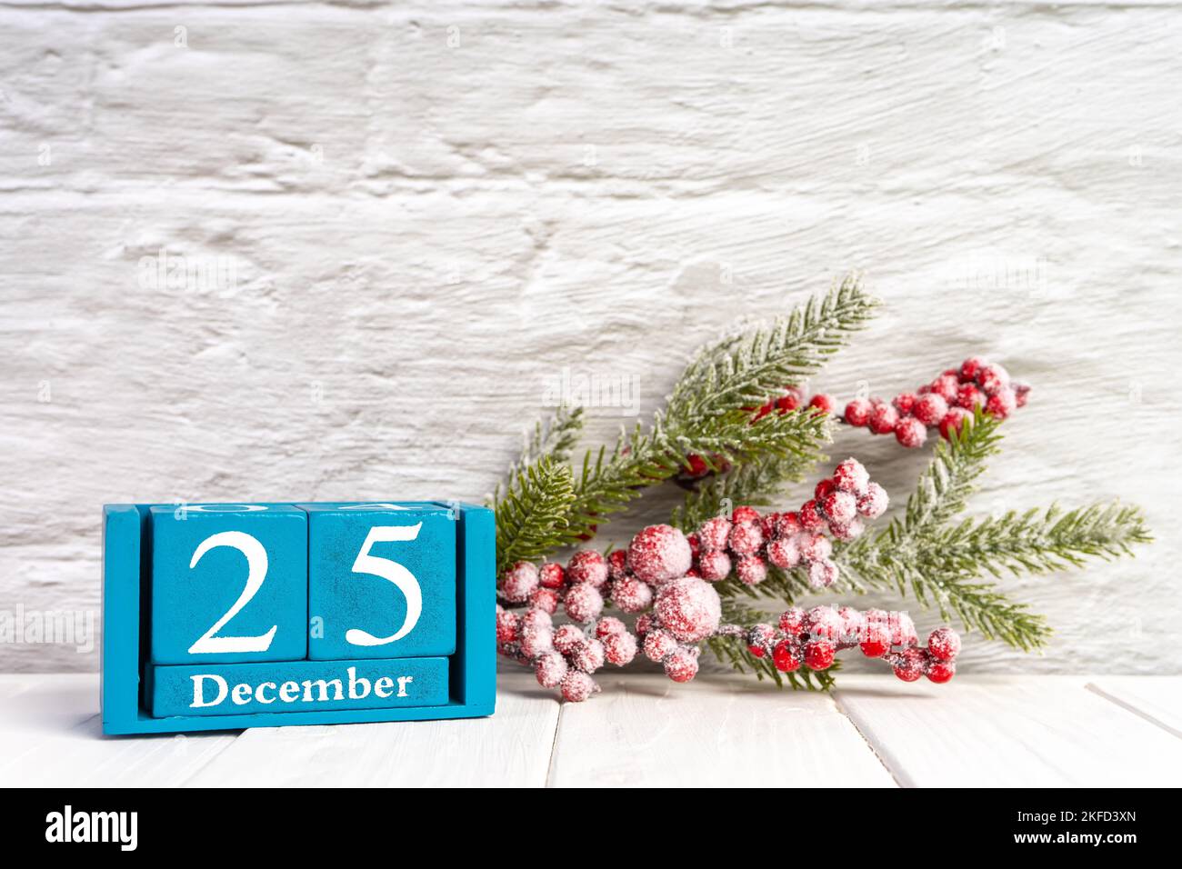 Christmas tree branch with red berries and blue perpetual calendar with ...