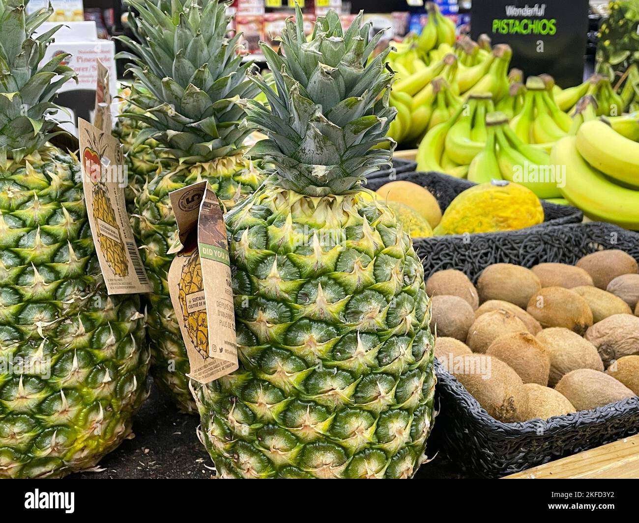 The fresh Pineapples and kiwis and bananas in a store Stock Photo - Alamy