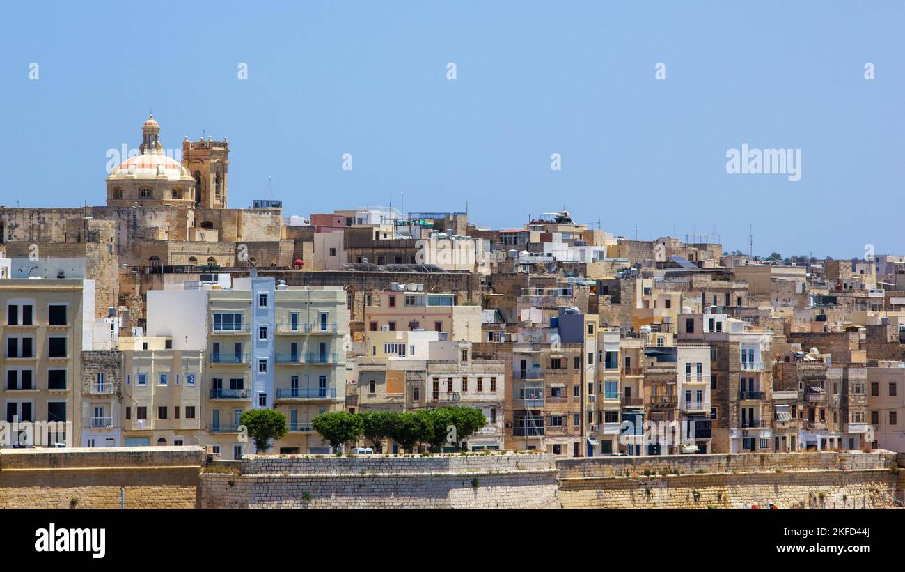 A shot of St Philip's Church and cascading colorful houses in Senglea ...