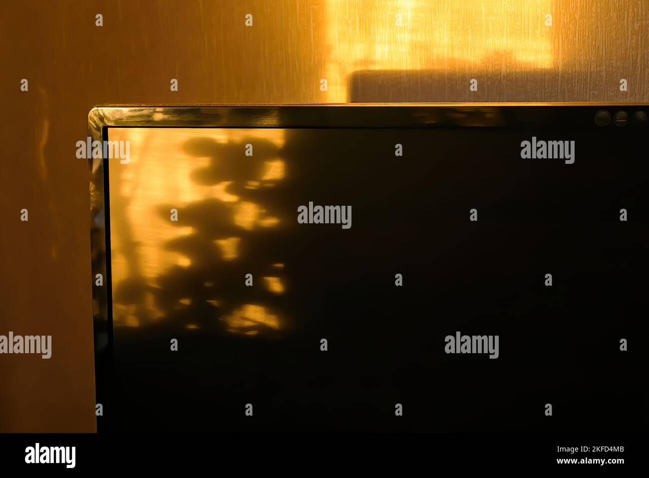 Sunbeams at sunset fall on computer desk in apartment. Ray of sun on ...