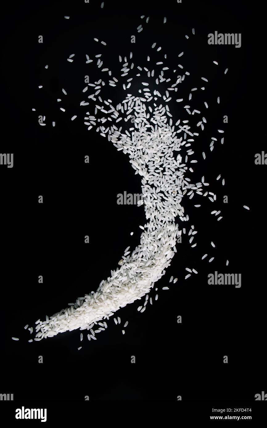 Raw white rice splash on black background. Uncooked rice explosion ...