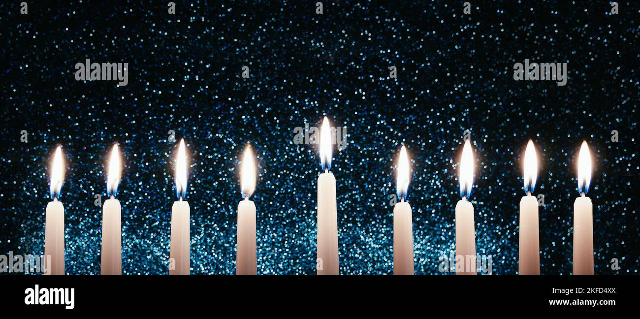 Hanukkah candles. Traditional candelabrum with burning candles on black ...