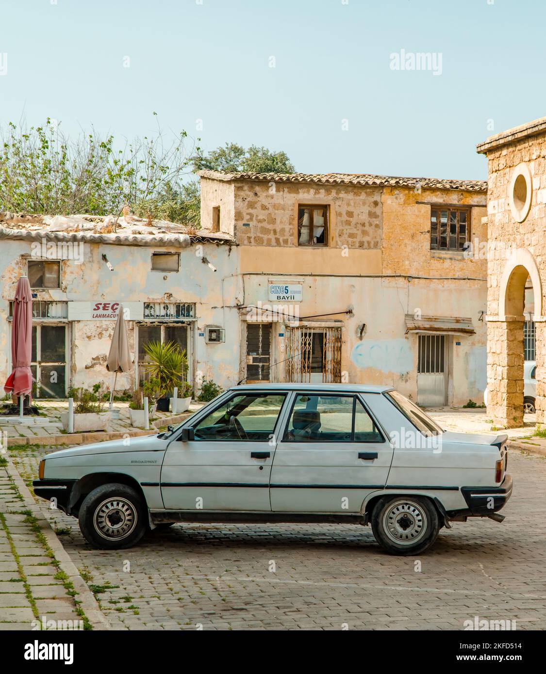 A vertical shot of an old car and medieval buildings in the Walled City ...