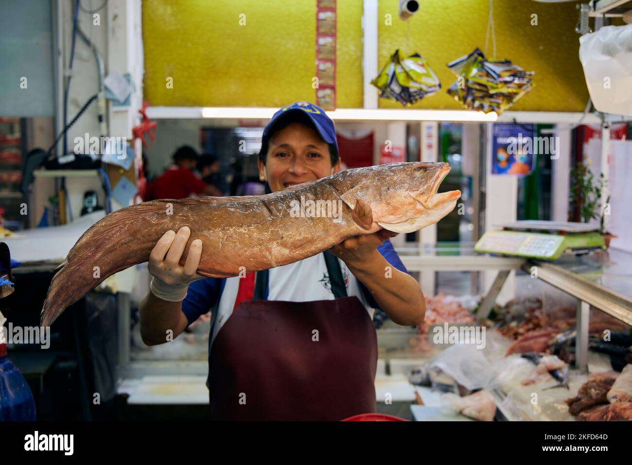 A Costa Rican market vendor lifting a fish in Stock Photo - Alamy
