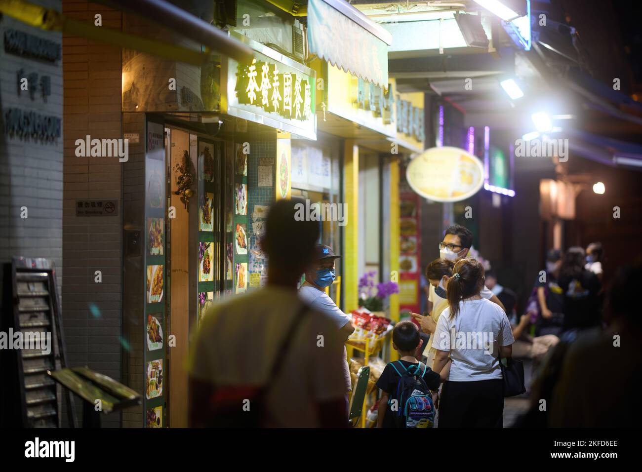 People waiting for a takeaway meal at night street in Kowloon city ...