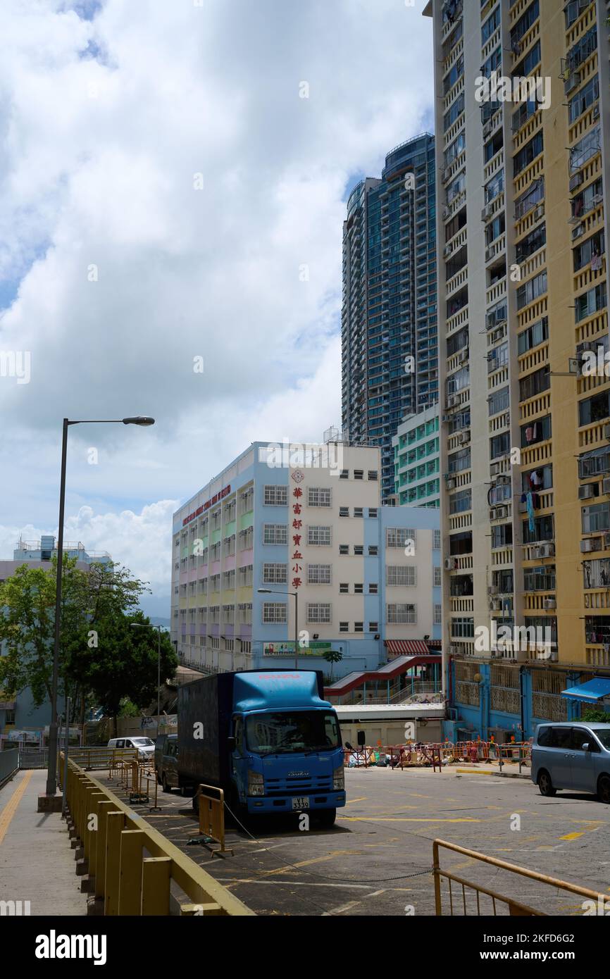A vertical urban shot of an old residential building in Wah Fu Estate ...