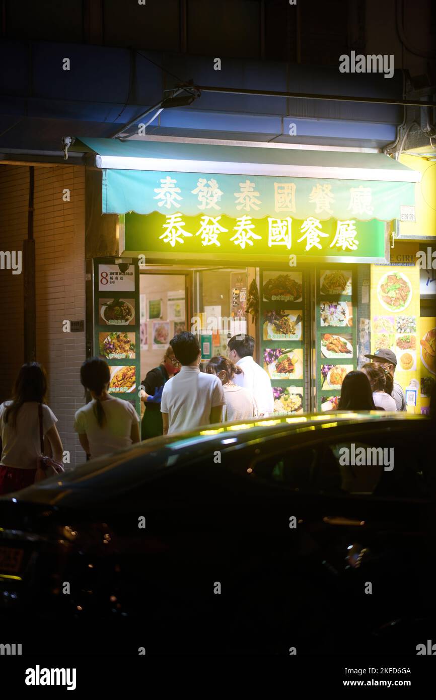 A group of people waiting in the line in Thai cuisine restaurant in ...