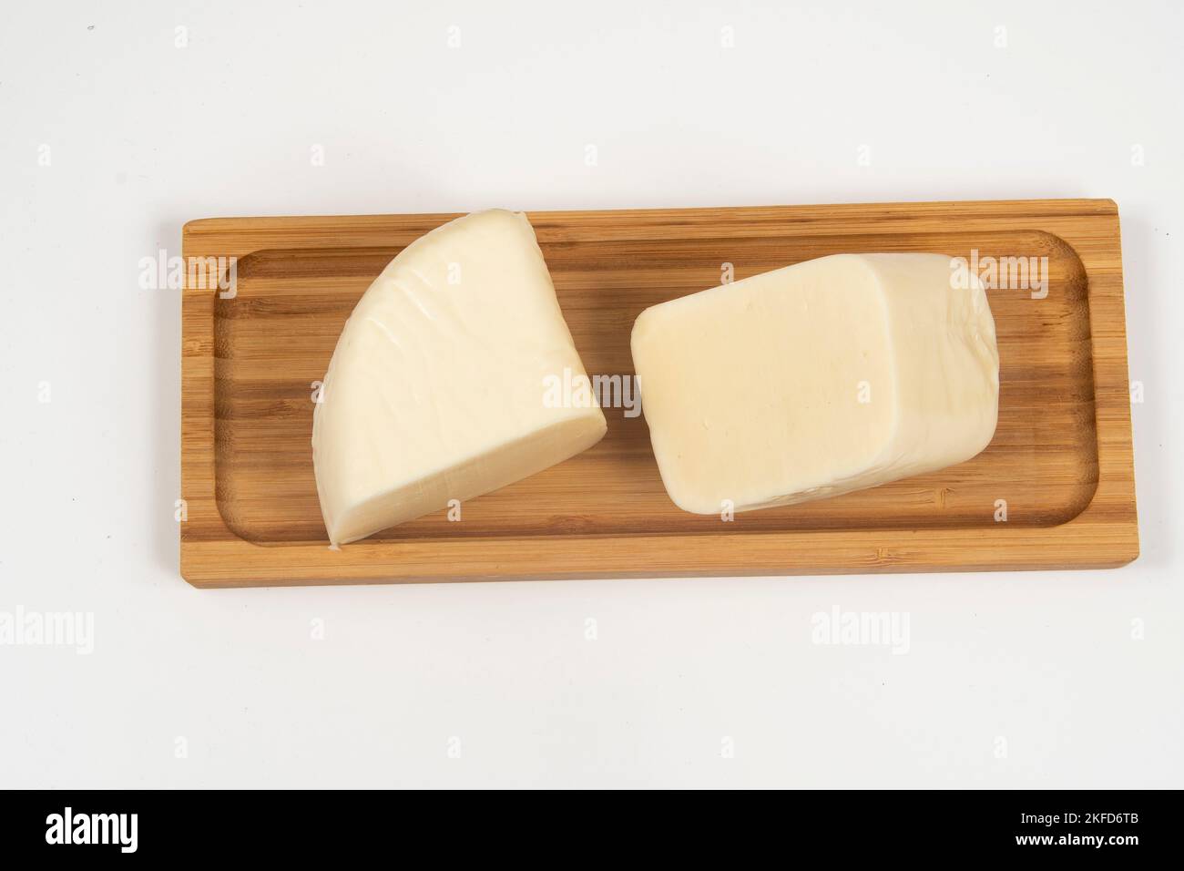 Minas half-cured cheese on a bamboo tray isolated Stock Photo - Alamy