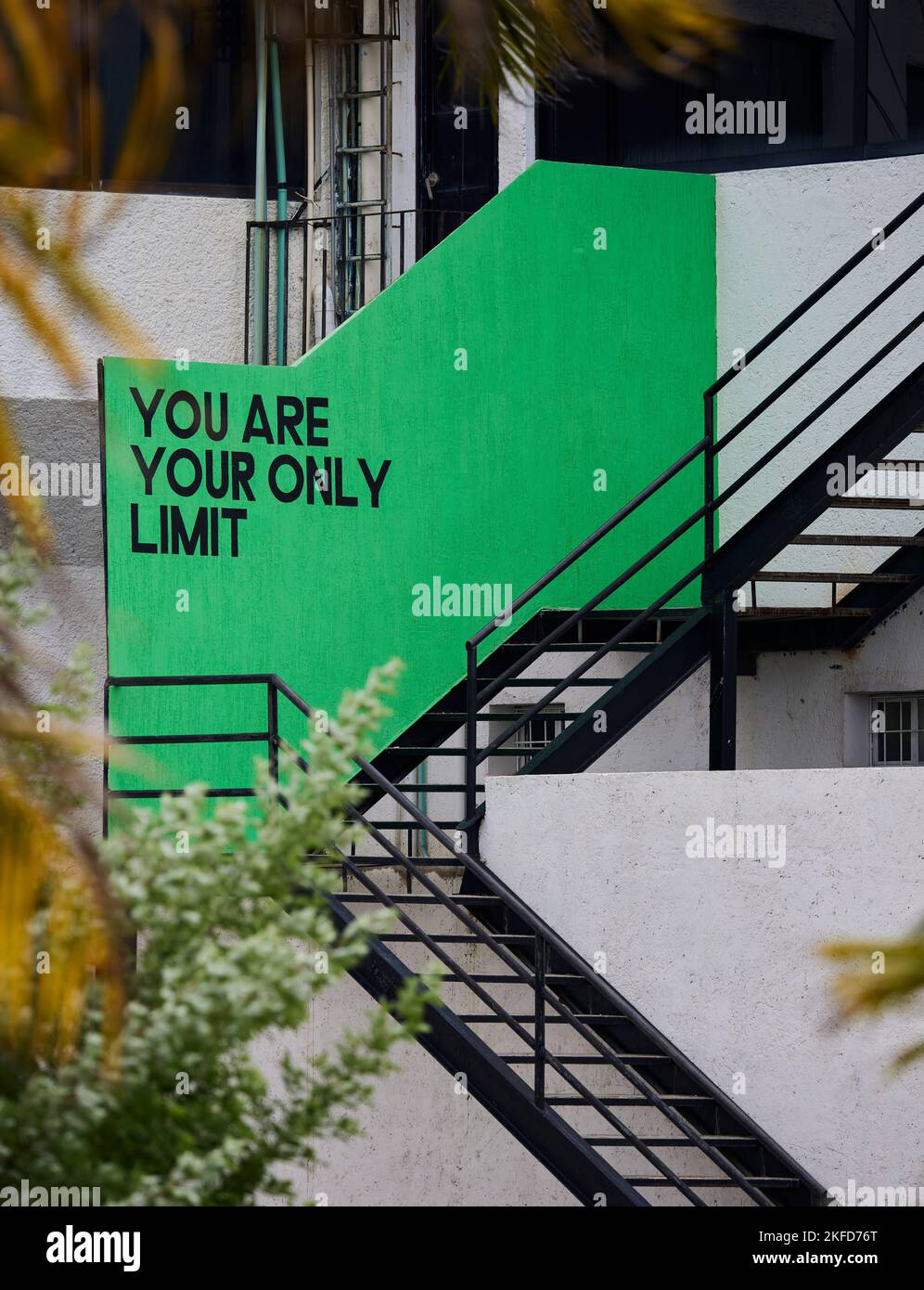A vertical shot of a graffiti of you are your only limit sign on the ...